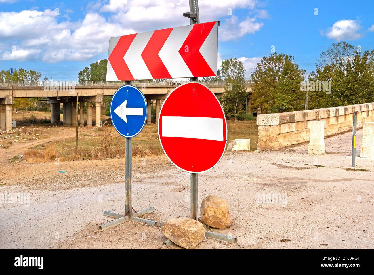 Traffic signs on the road showing directions for different places ...