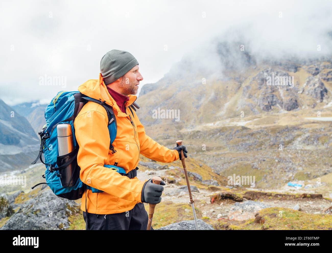 Portrait of caucasian man with backpack and trekking poles in Makalu ...