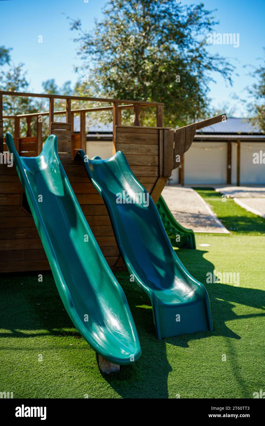 Slides at a childrens playground Stock Photo - Alamy