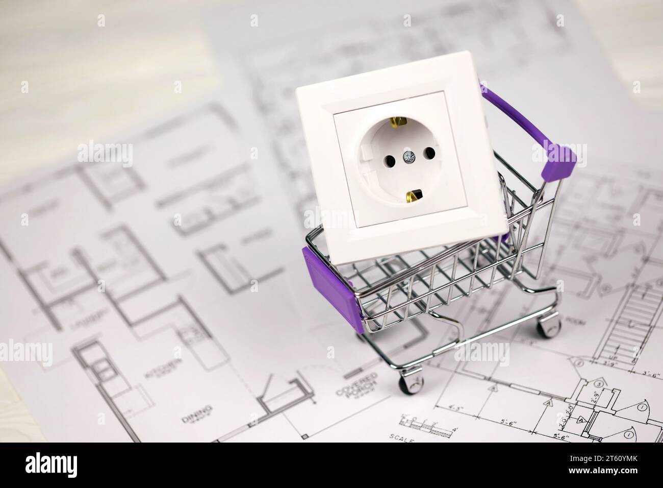 European standard EU outlet in small shopping cart on blueprints of ...