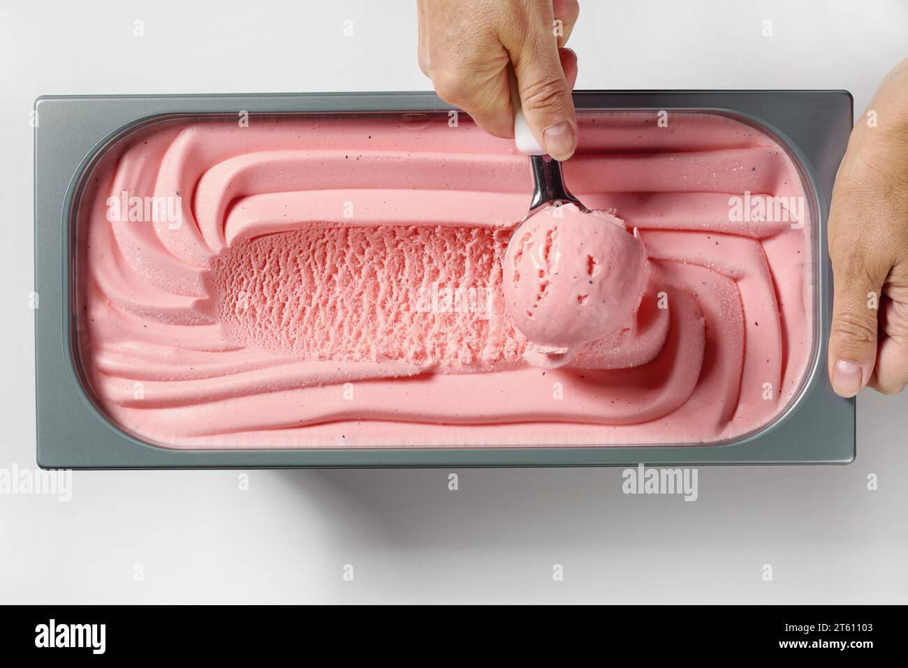 pink strawberry ice cream scooping out of container, top view Stock ...