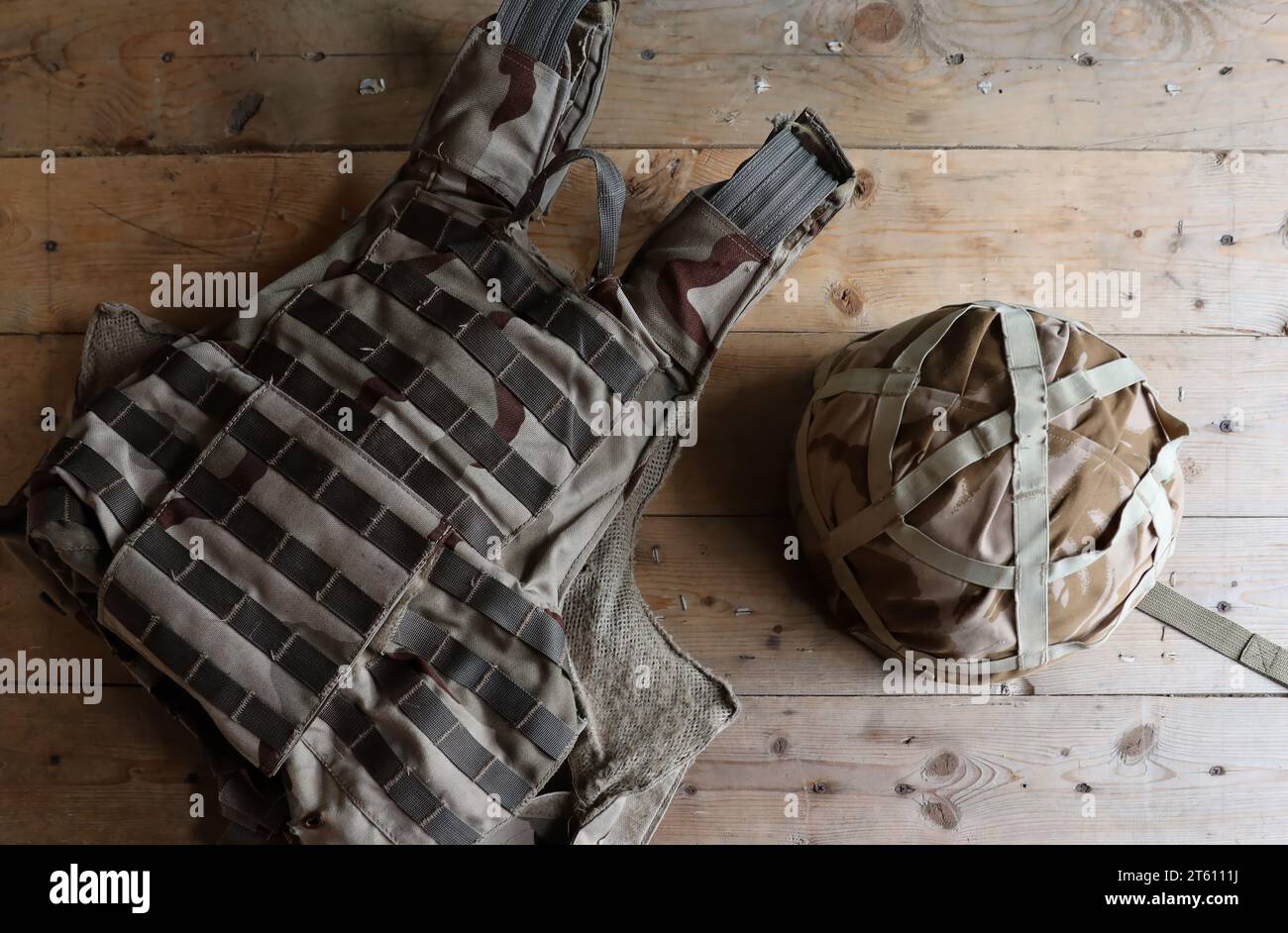 A military helmet of a Ukrainian soldier with a heavy bulletproof vest ...