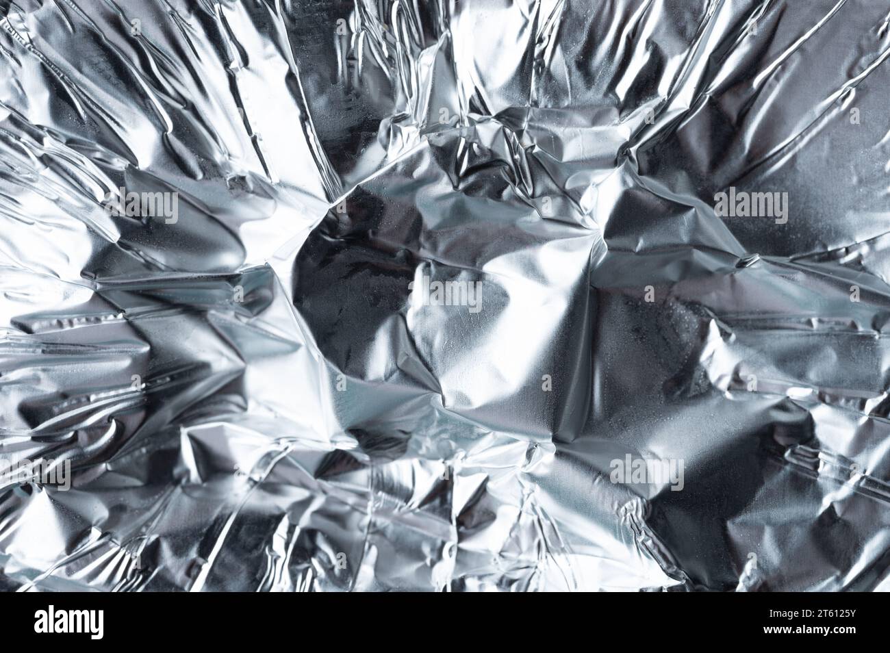 Close up view on crumpled foil background. Texture of bright metal ...
