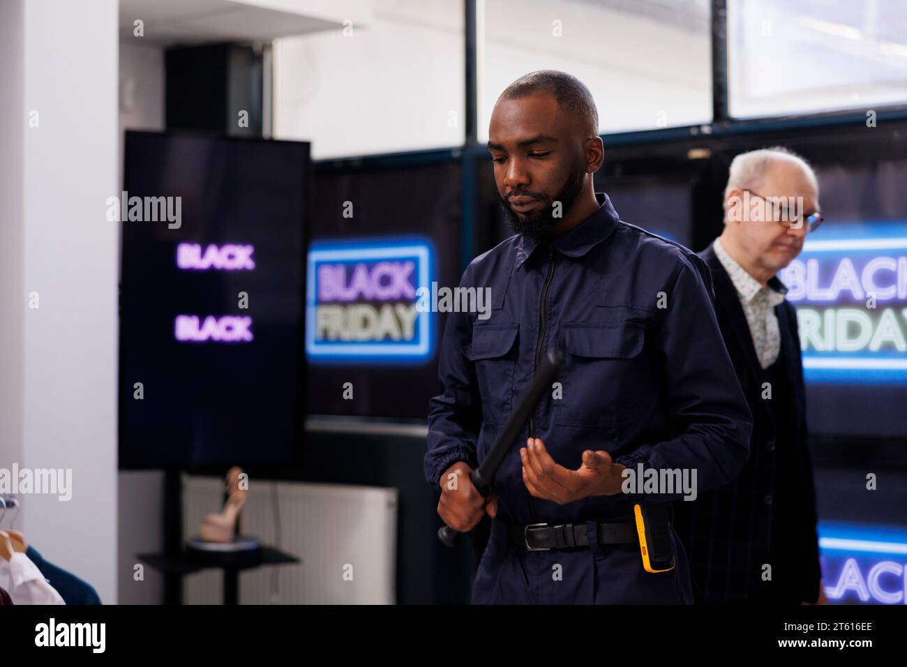 Serious African American man security officer in uniform patrolling ...
