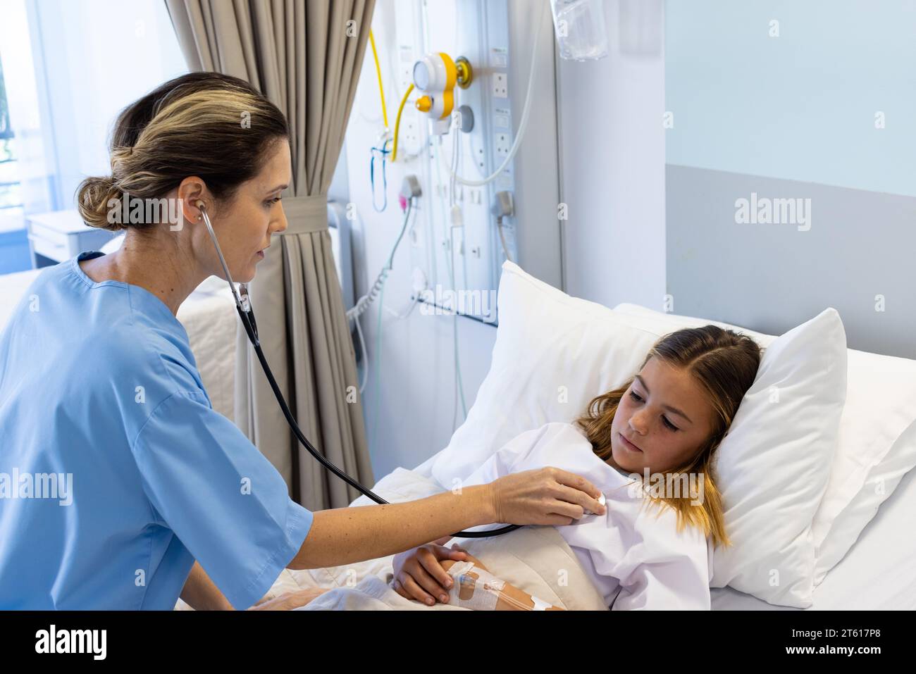 Focused caucasian female doctor using stethoscope on chest of girl ...