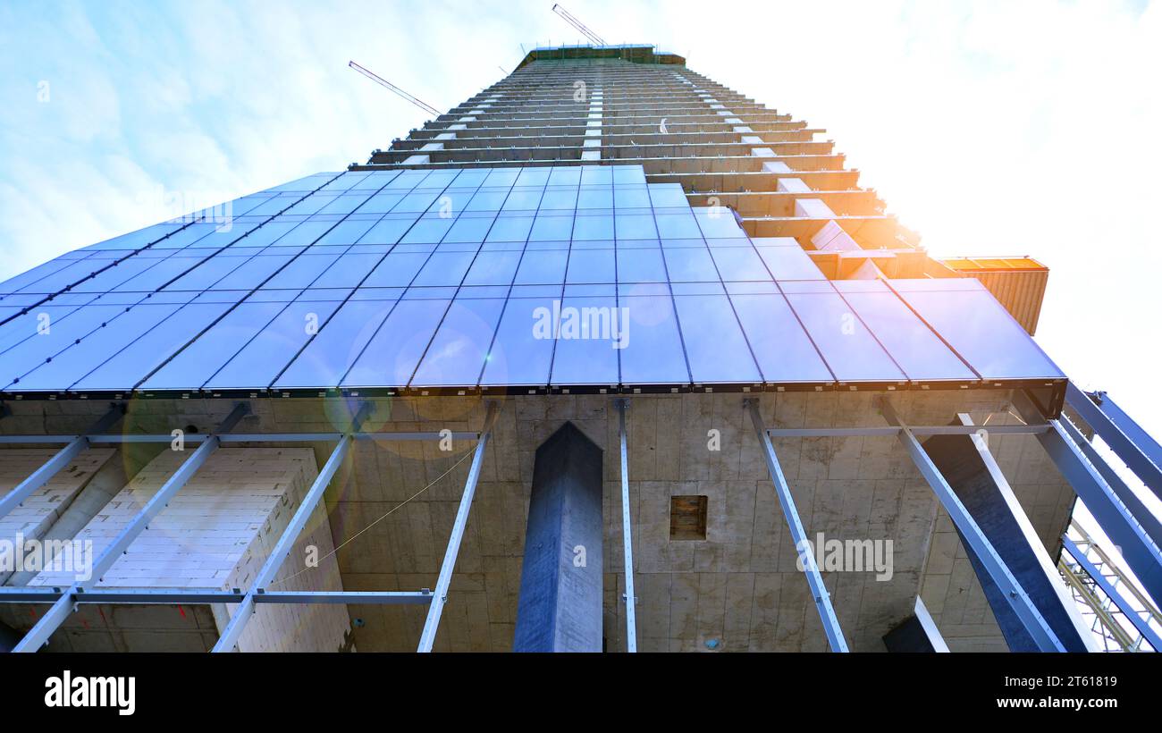 High rise building under construction. Installation of glass facade ...