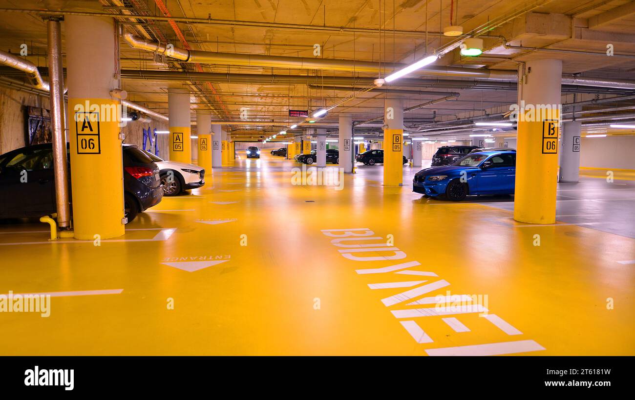 Underground parking under shopping center. Car parking garage with ...