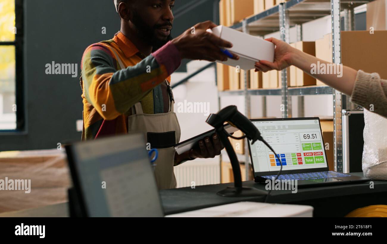 Male worker preparing boxes with goods for retail store delivery ...
