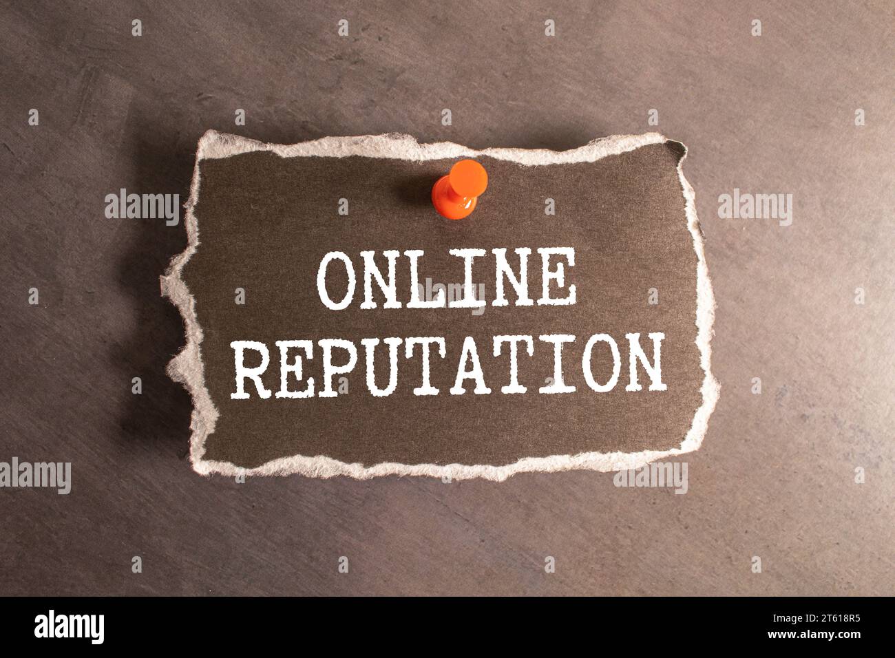 Businessman holding a card with text ONLINE REPUTATION Keyboard ...