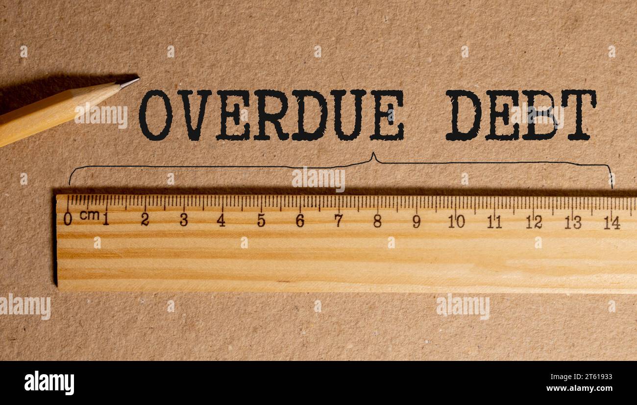 OVERDUE DEBT text on a blue background with keyboard and clipboard ...