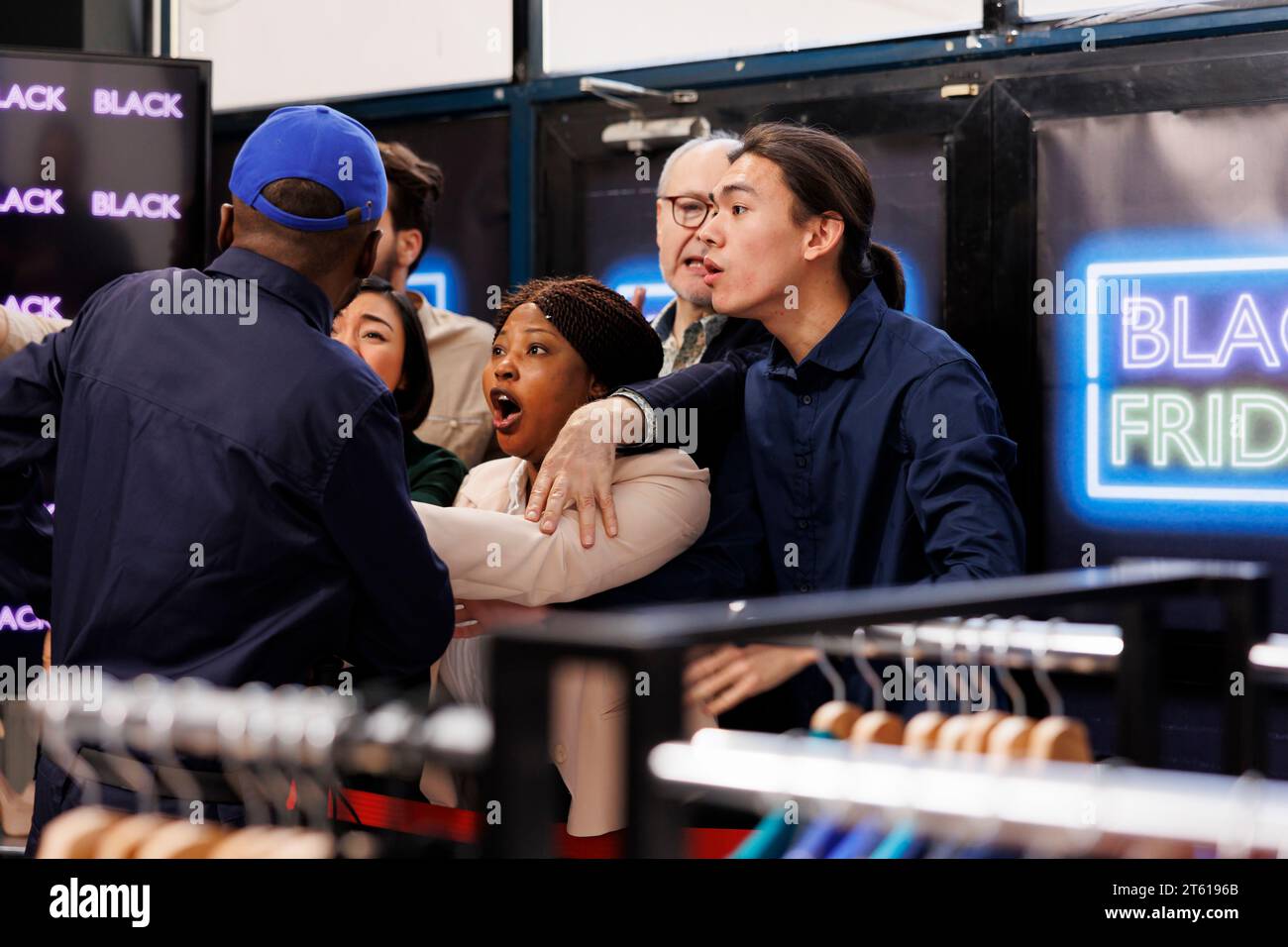 Crowd of diverse people standing at clothing store entrance going crazy ...