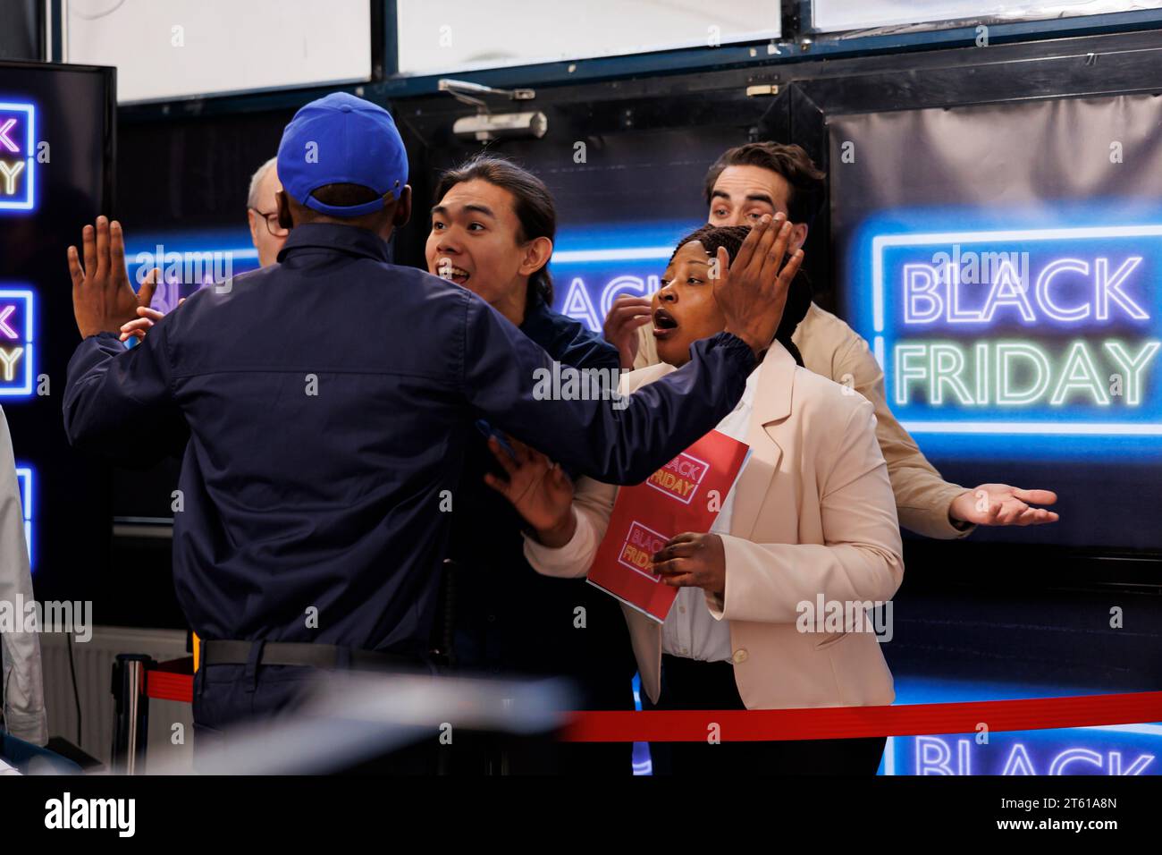 Security officer holding back angry eager shoppers waiting for Black ...