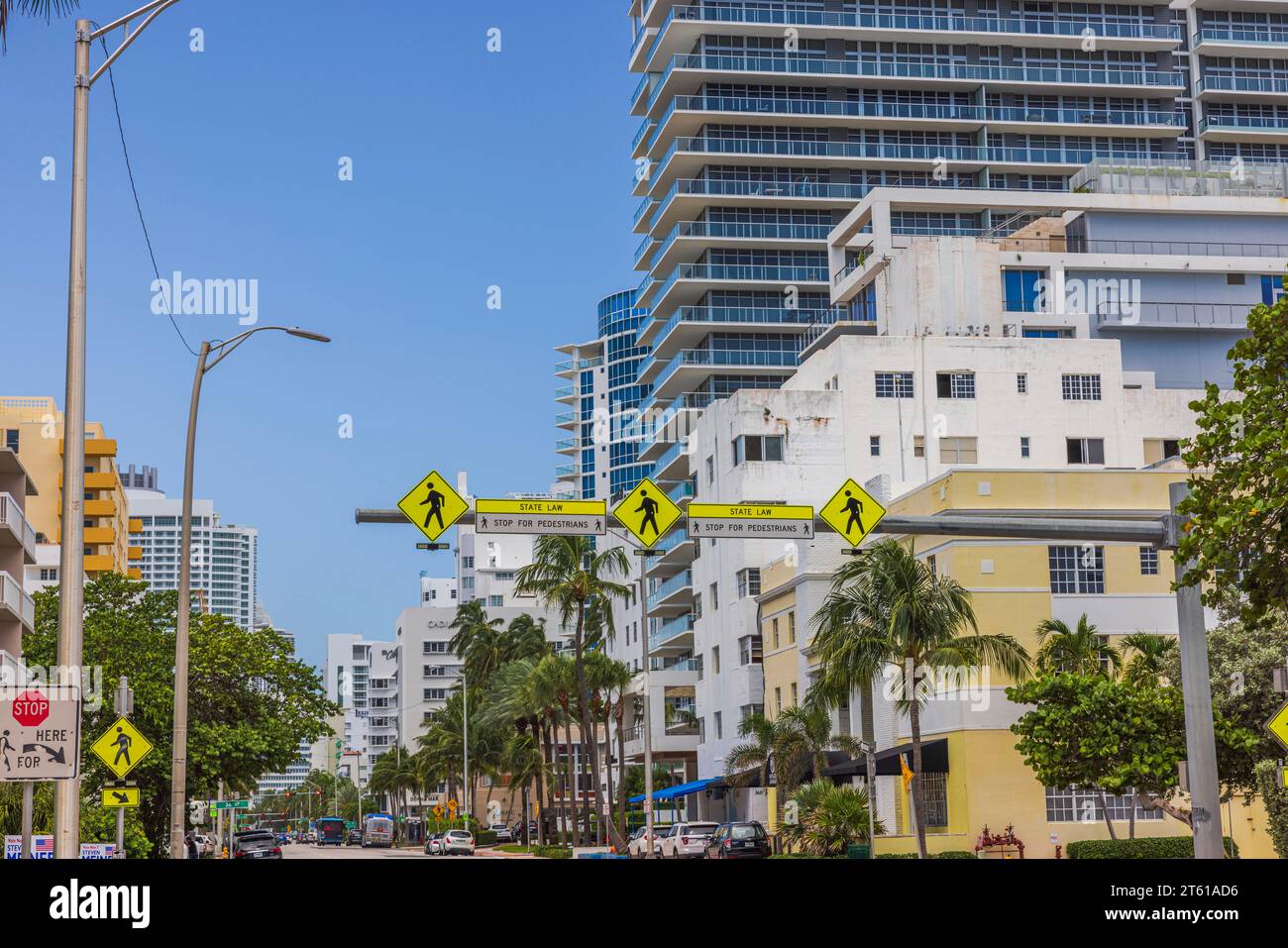 Accentuated long pedestrian crosswalk sign hangs over one of Miami ...