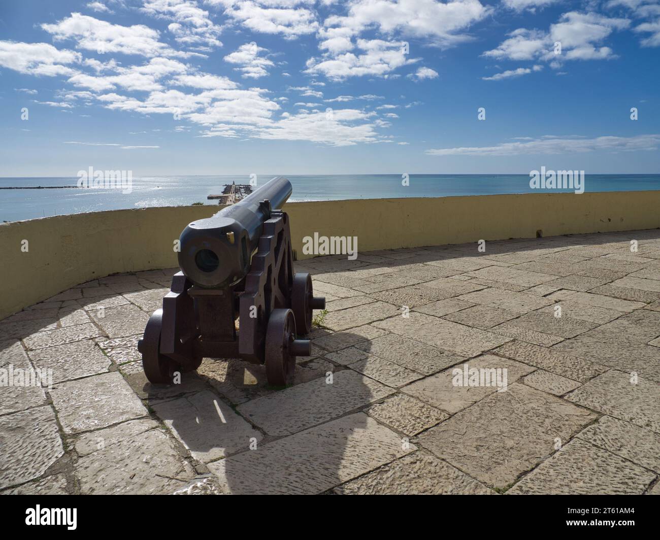 Iron Cannon Pointing Towards the Vast Ocean Horizon with blue sky ...