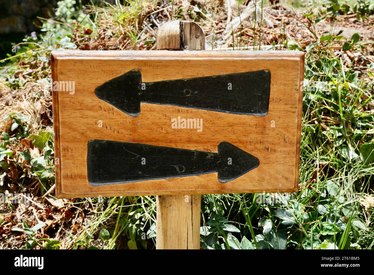 Brown wooden sign with 2 arrows pointing in opposite directions Stock ...