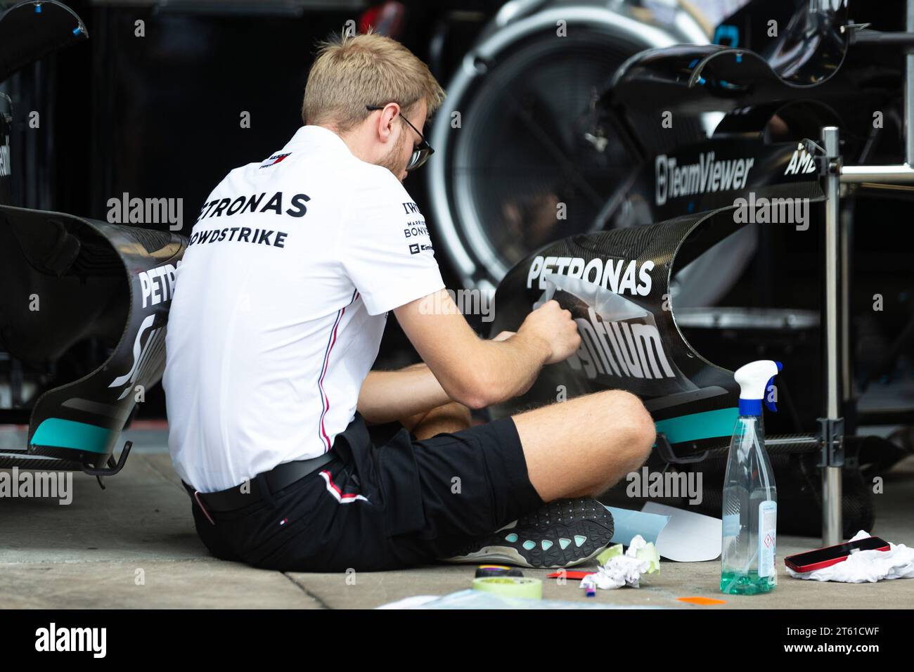 MECHANICS working on the MERCEDES-AMG PETRONAS F1 TEAM car at the garage as part of the 2023 F1 ...