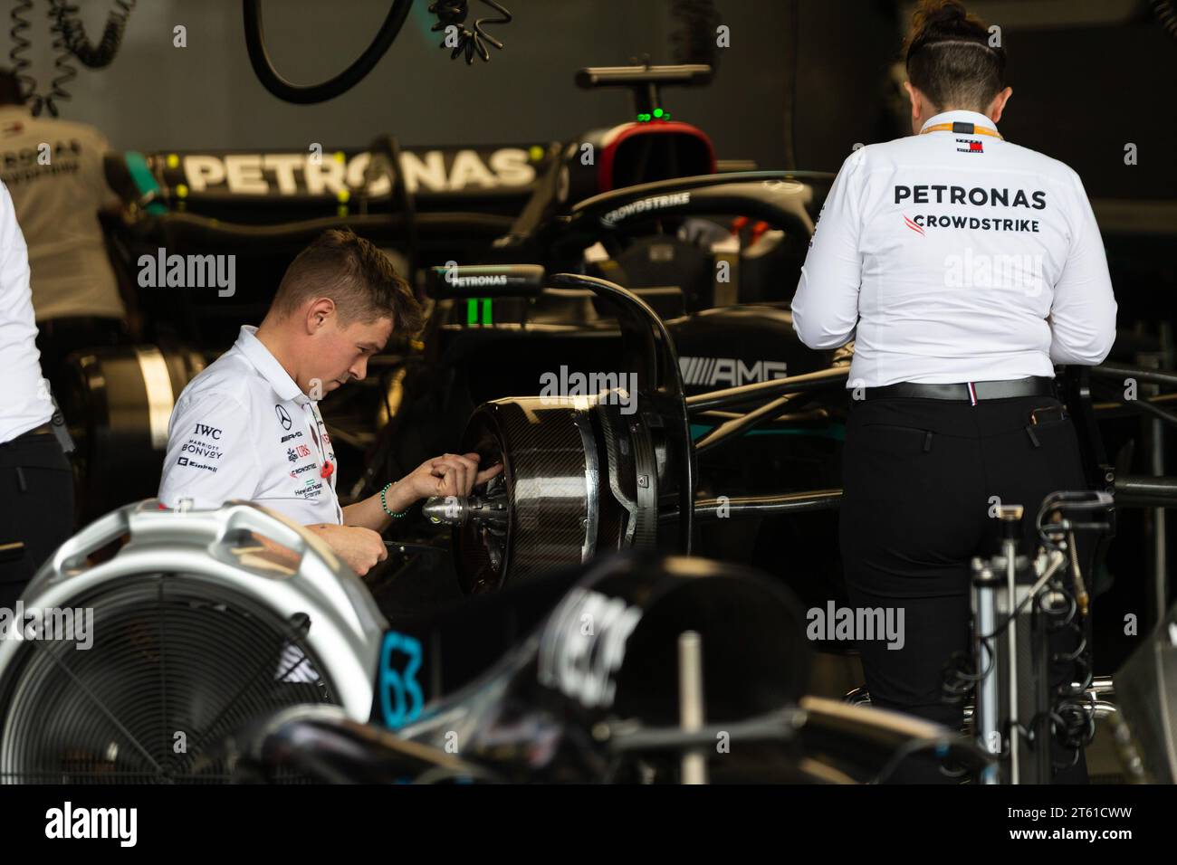 MECHANICS working on the MERCEDES-AMG PETRONAS F1 TEAM car at the garage as part of the 2023 F1 ...
