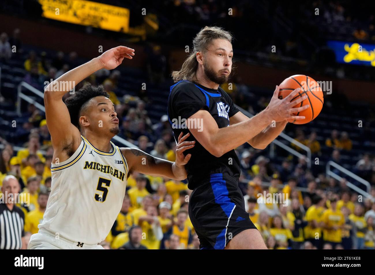 North Carolina Asheville forward Drew Pember grabs a rebound next to ...