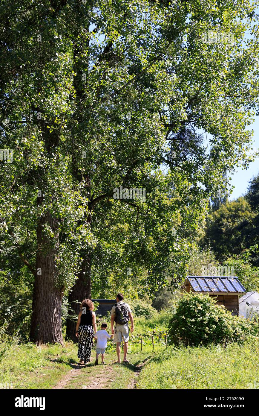 Family walk, child, father and mother, along the Vézère river in the ...