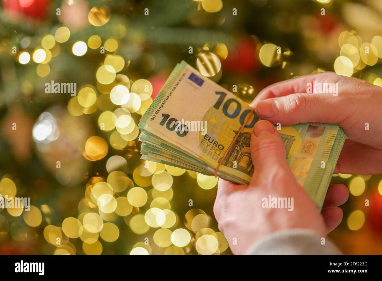 Christmas expenses and bills. euro money in hands on a Christmas ...