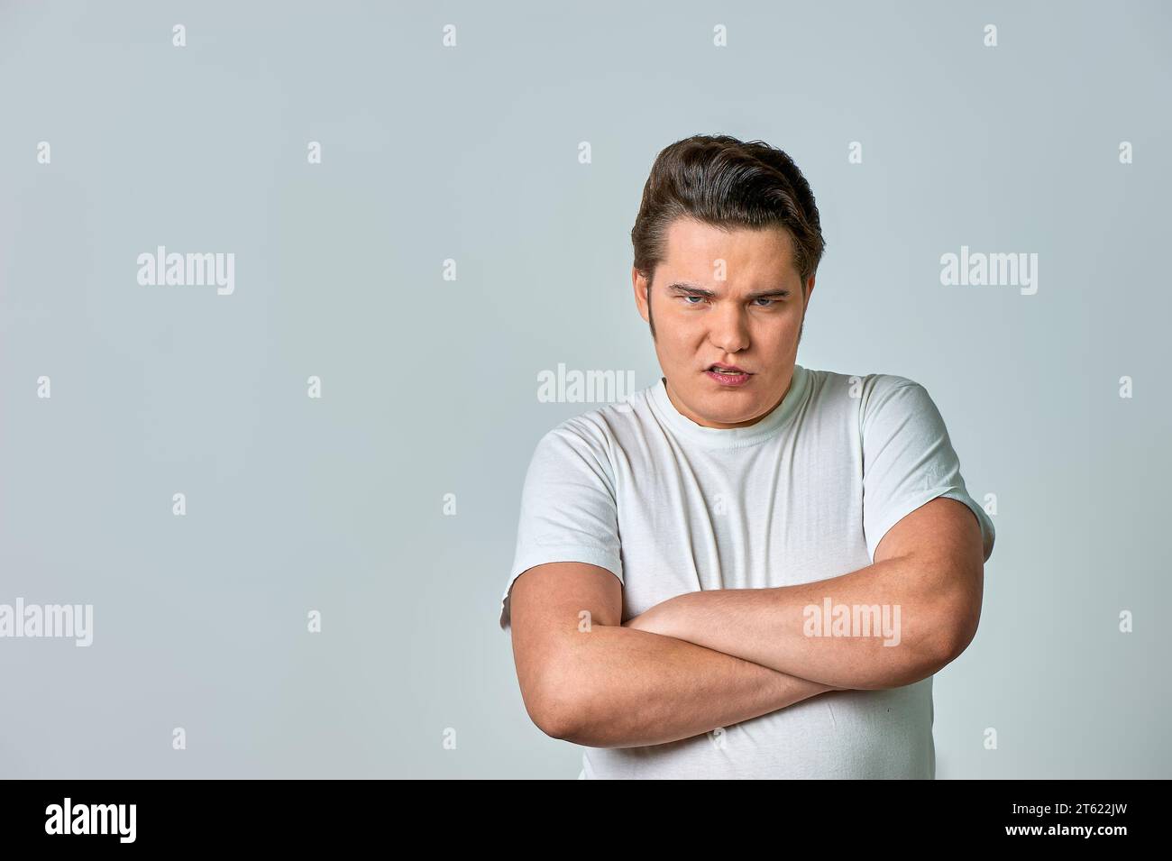 Angry, frowning man on a gray background, copy space Stock Photo - Alamy