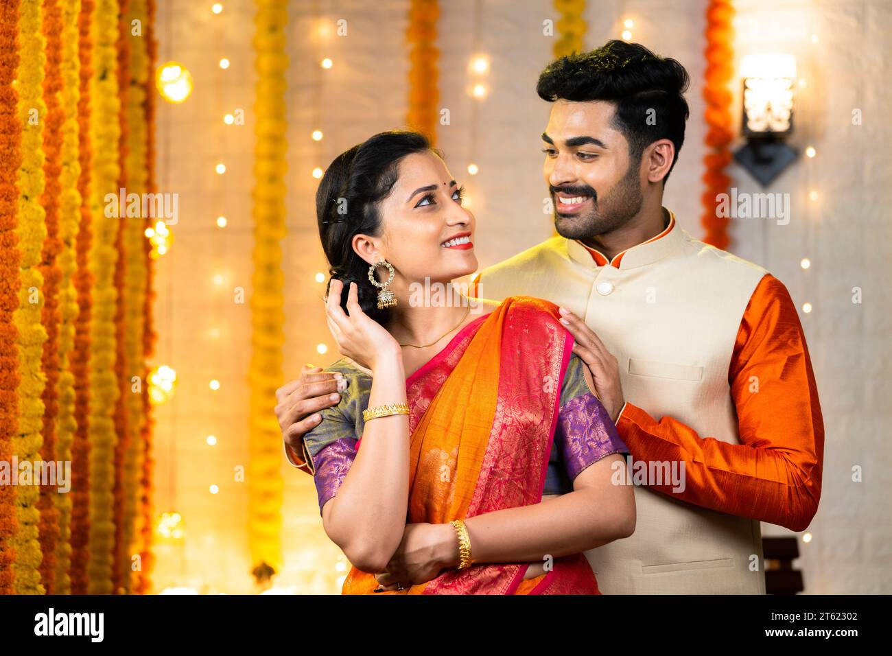 Happy smiling indian couple with traditional ethnic wear looking each ...
