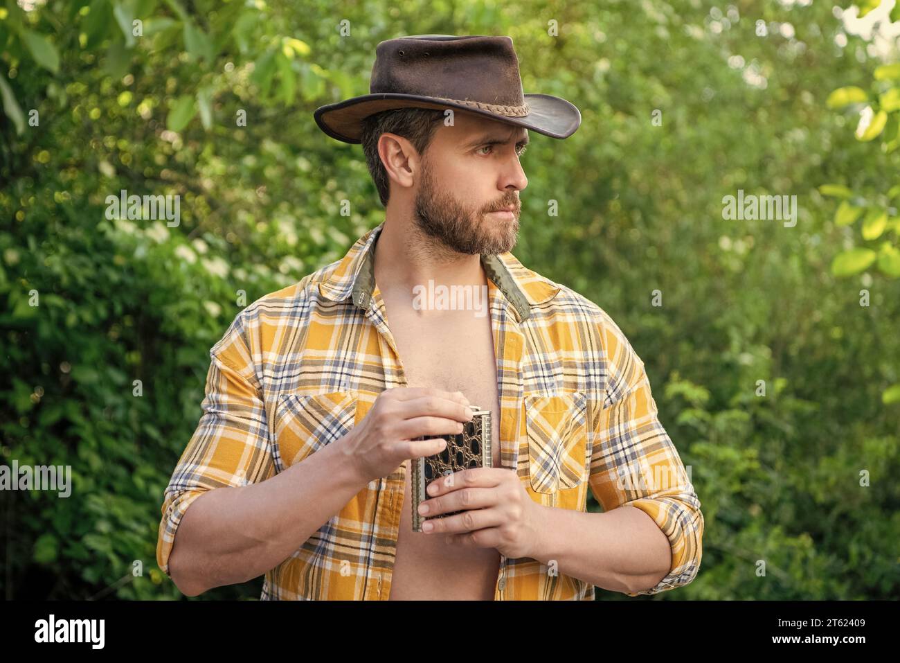 western man with whiskey flask outdoor. western man with whiskey flask ...