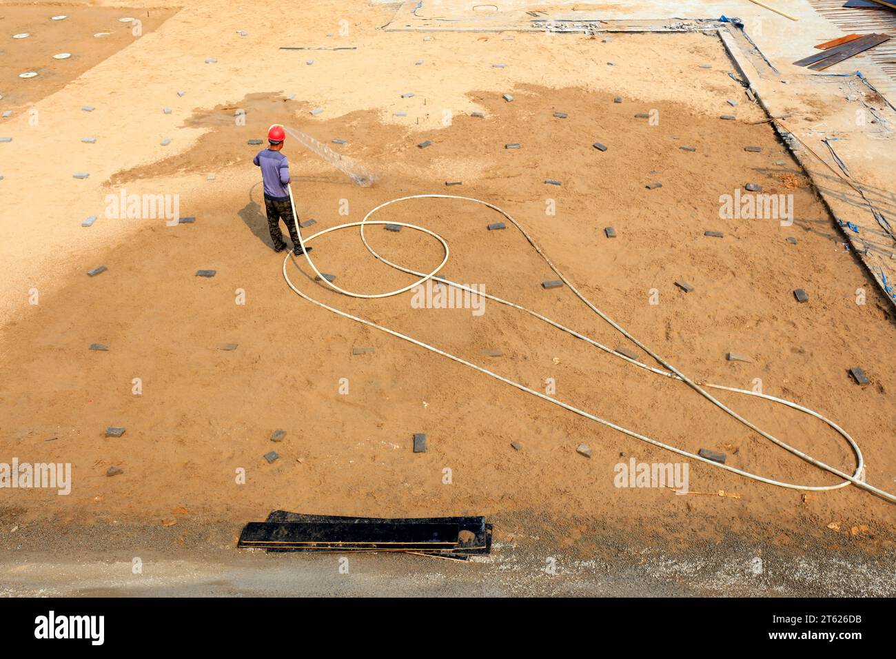 workers watering in the construction site Stock Photo - Alamy