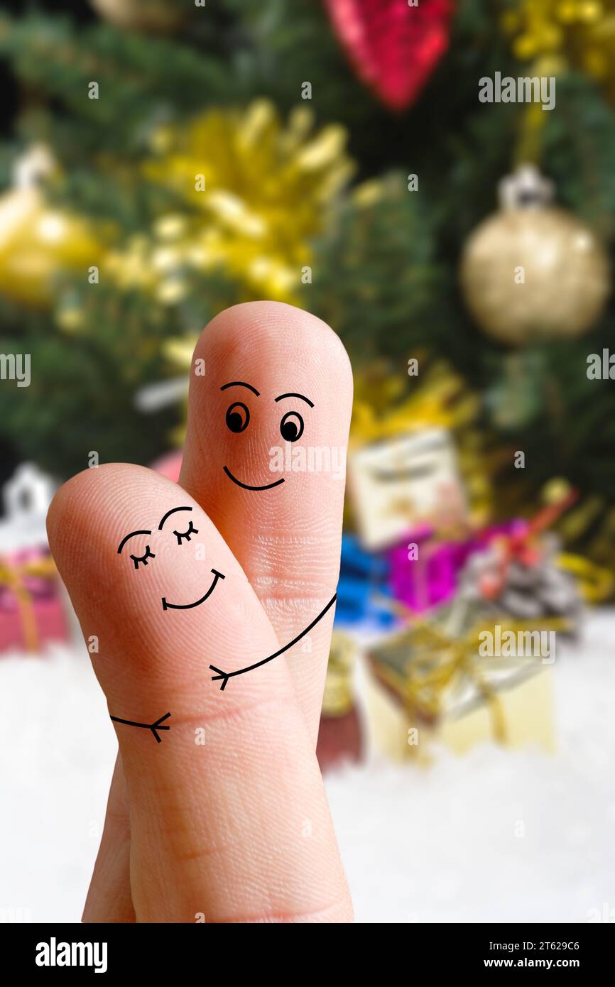 Faces of fingers hugging each other isolated on Christmas decorated ...