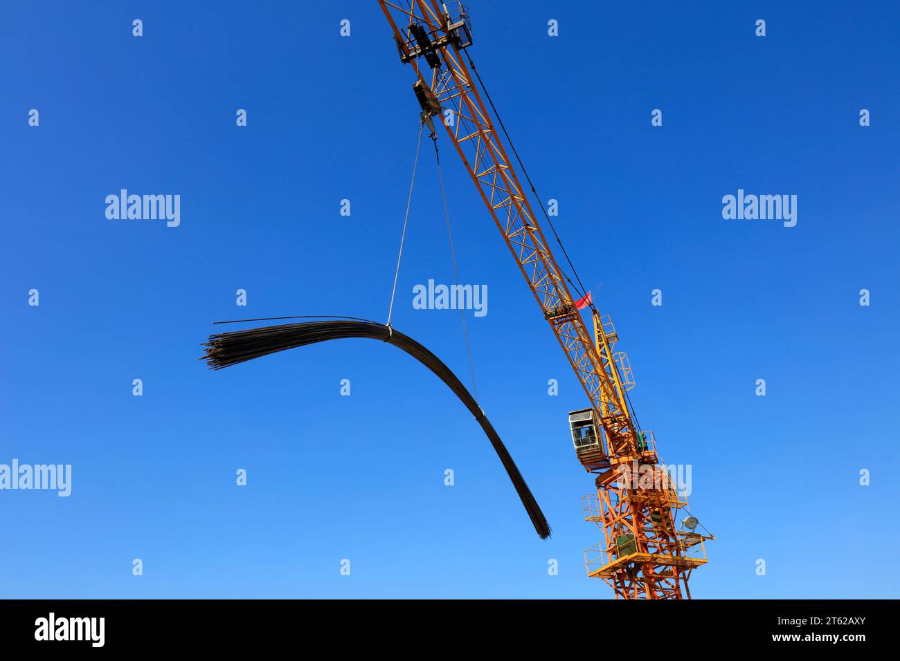 Hoisting steel bar in the construction site Stock Photo - Alamy