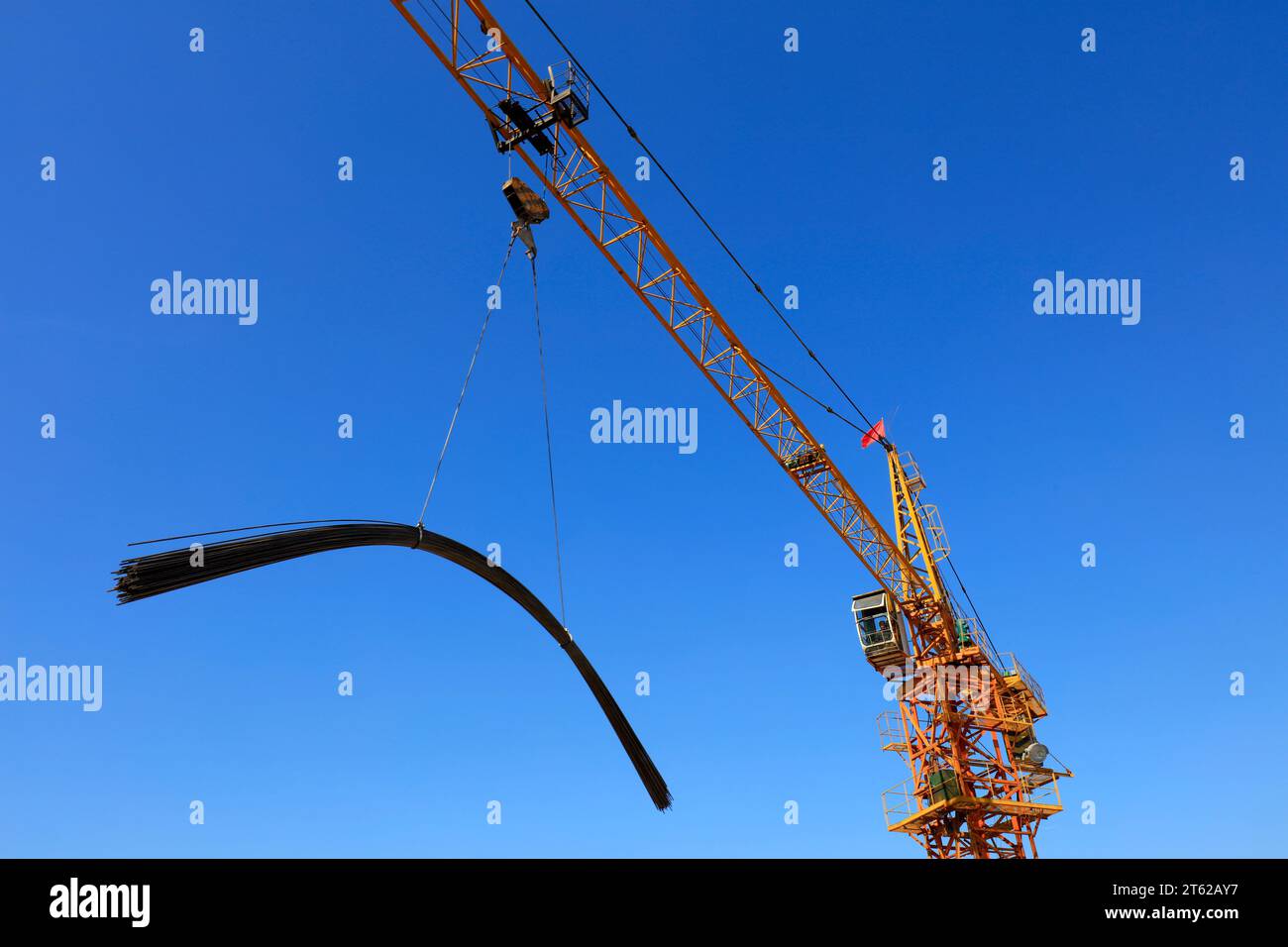 Hoisting steel bar in the construction site Stock Photo - Alamy
