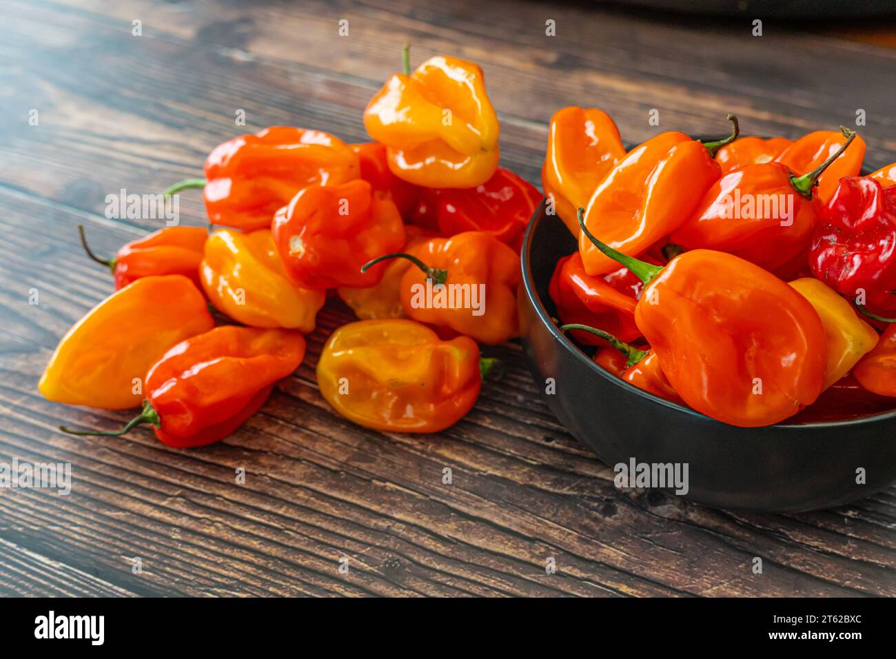 Scotch Bonnet hot spicy Peppers on wood Kitchen table Stock Photo - Alamy