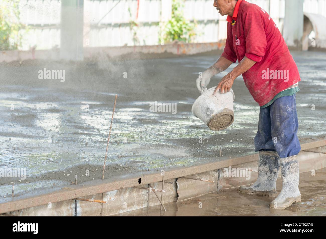Worker scatter cement powder on surface of wet concrete insert Metal ...