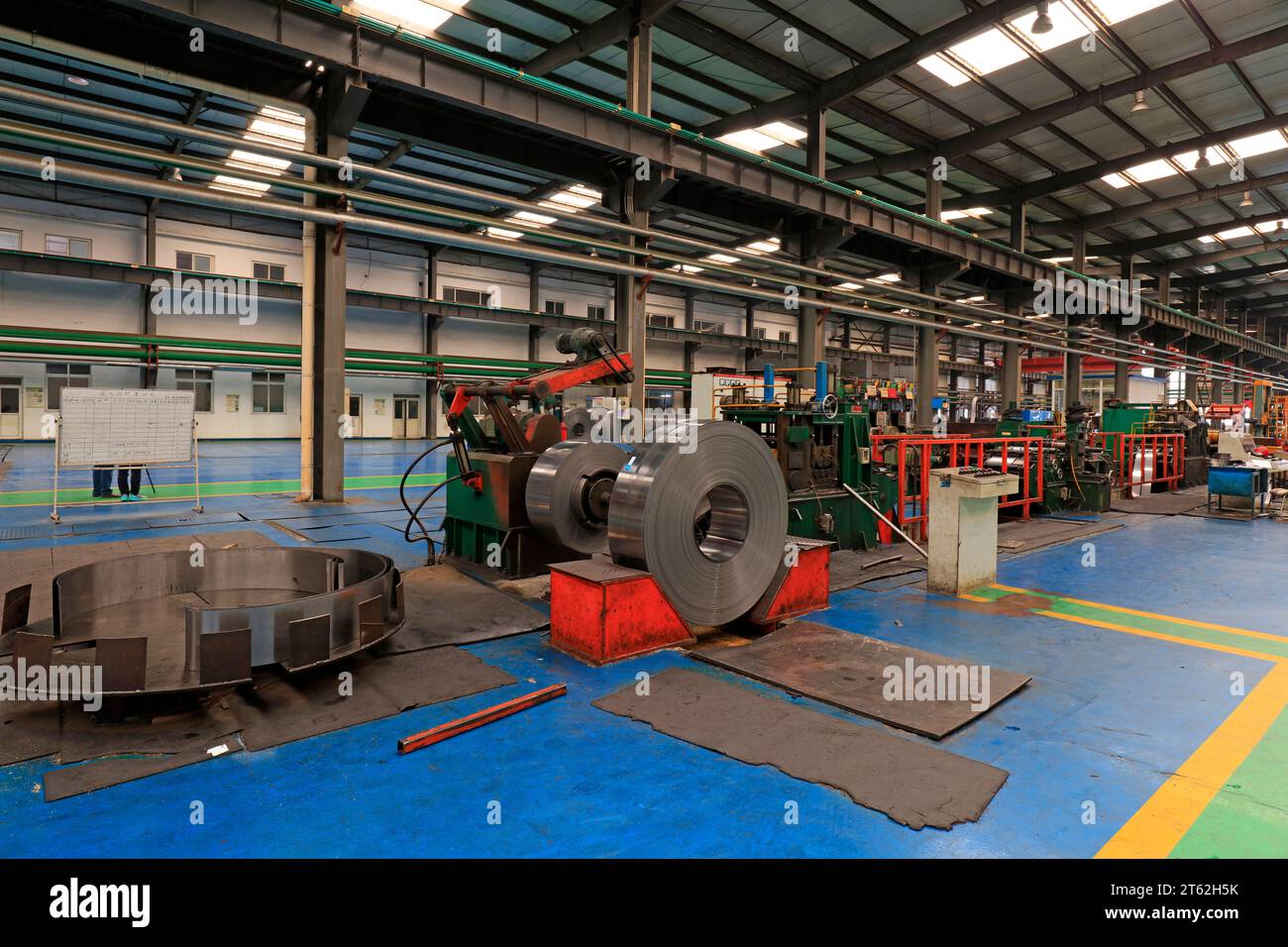 Strip steel and machinery in the workshop Stock Photo - Alamy