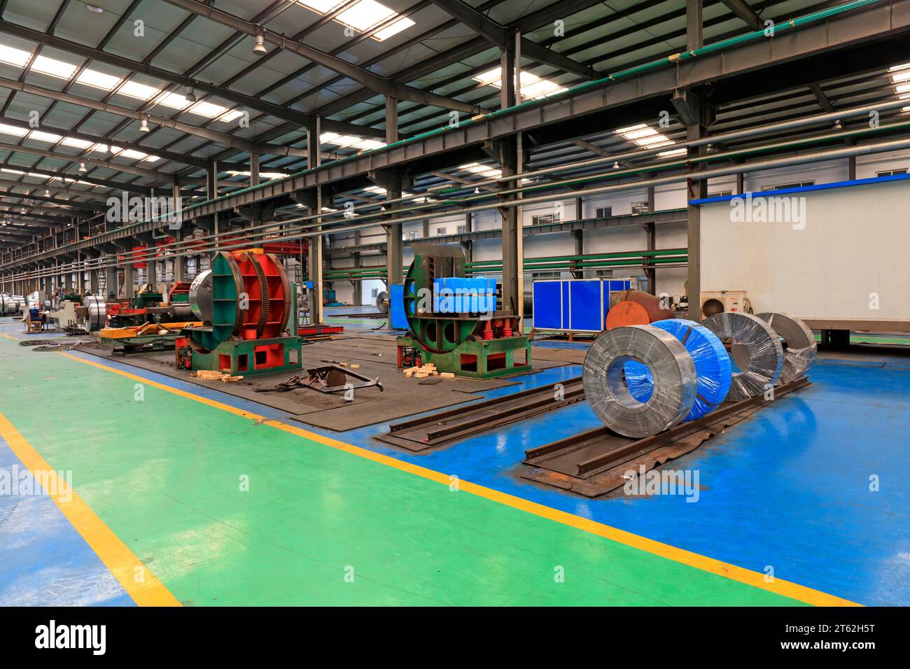 Strip steel and machinery in the workshop Stock Photo - Alamy