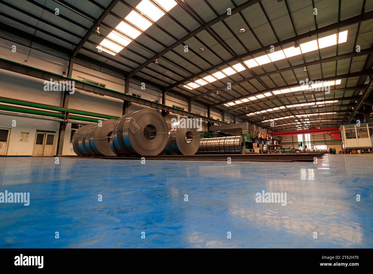 Strip steel and machinery in the workshop Stock Photo - Alamy