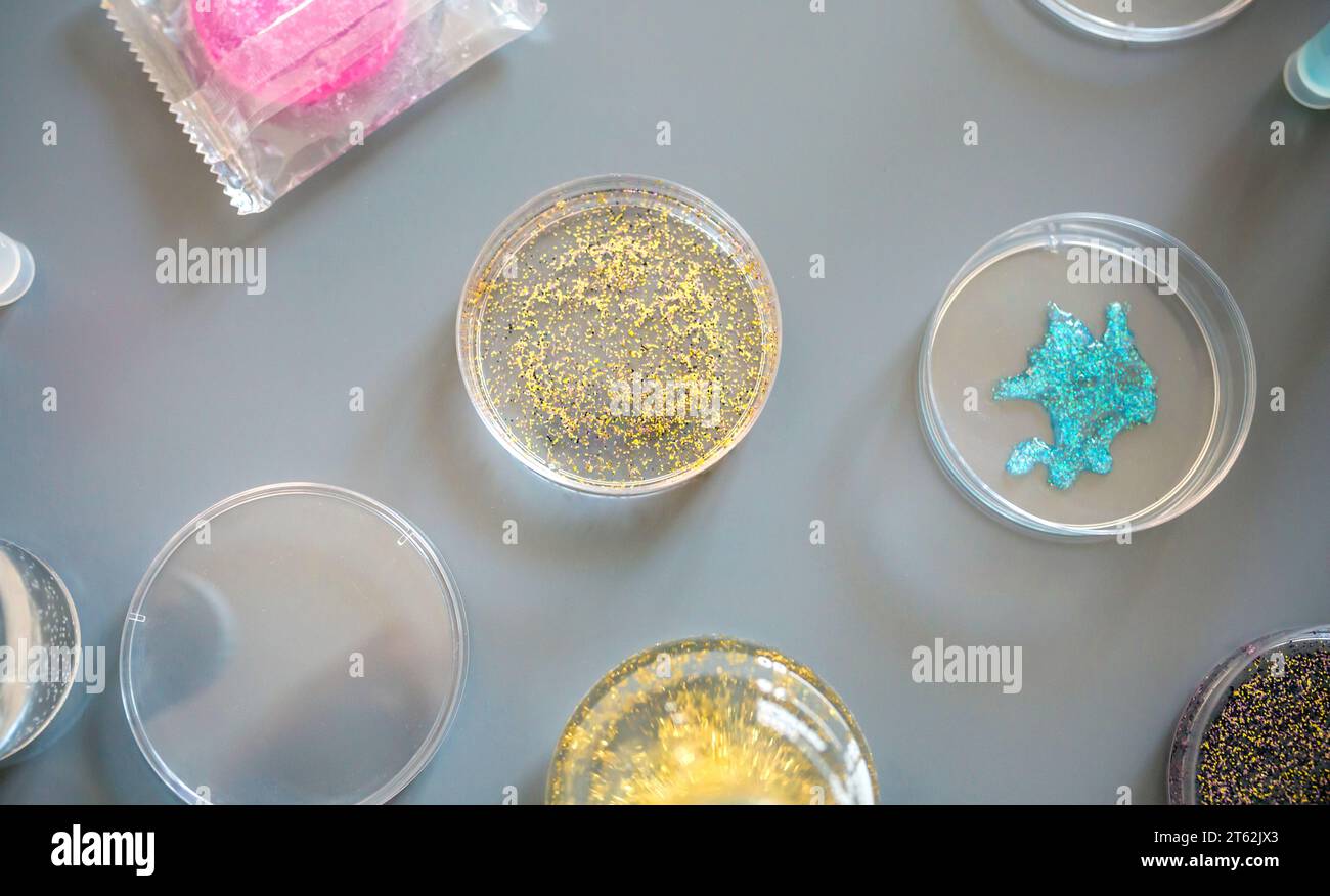 Top view of different glitter samples in petri dishes over a lab table ...
