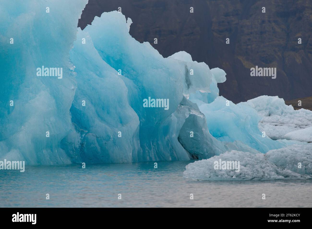 A tranquil scene of a lake with small pieces of ice melting and ...