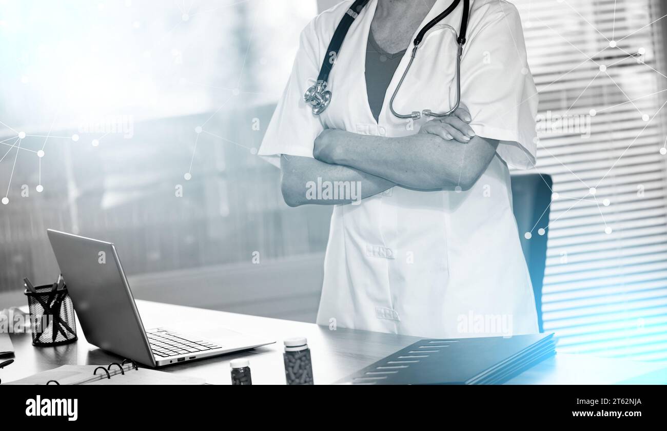 Female doctor with arms crossed in medical office; light effect Stock ...
