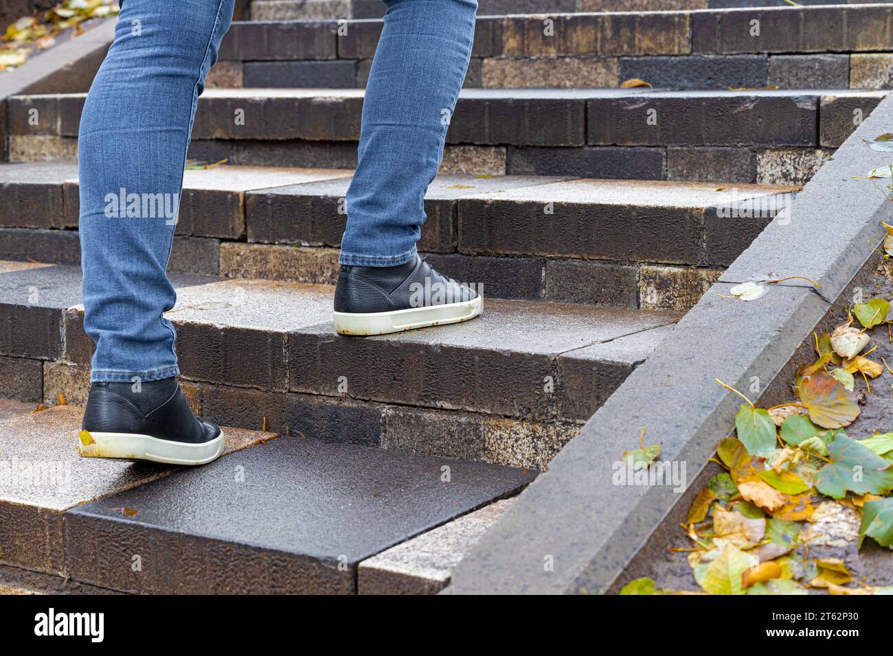 man climbs stone stairs in the park. man walking up the stairs Stock ...
