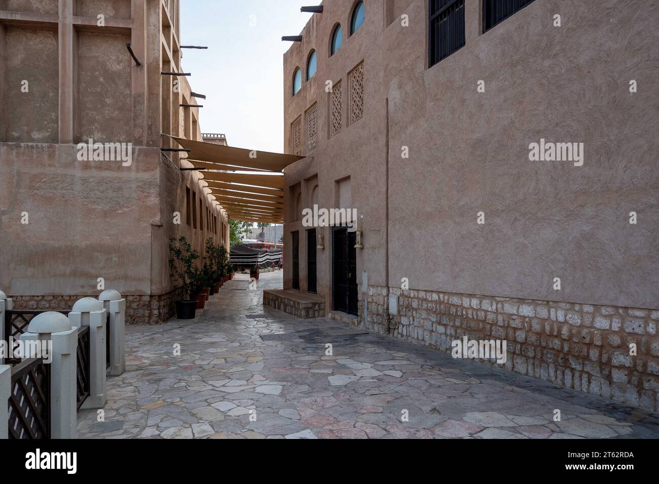 View of narrow clean streets between traditional stone buildings in old ...