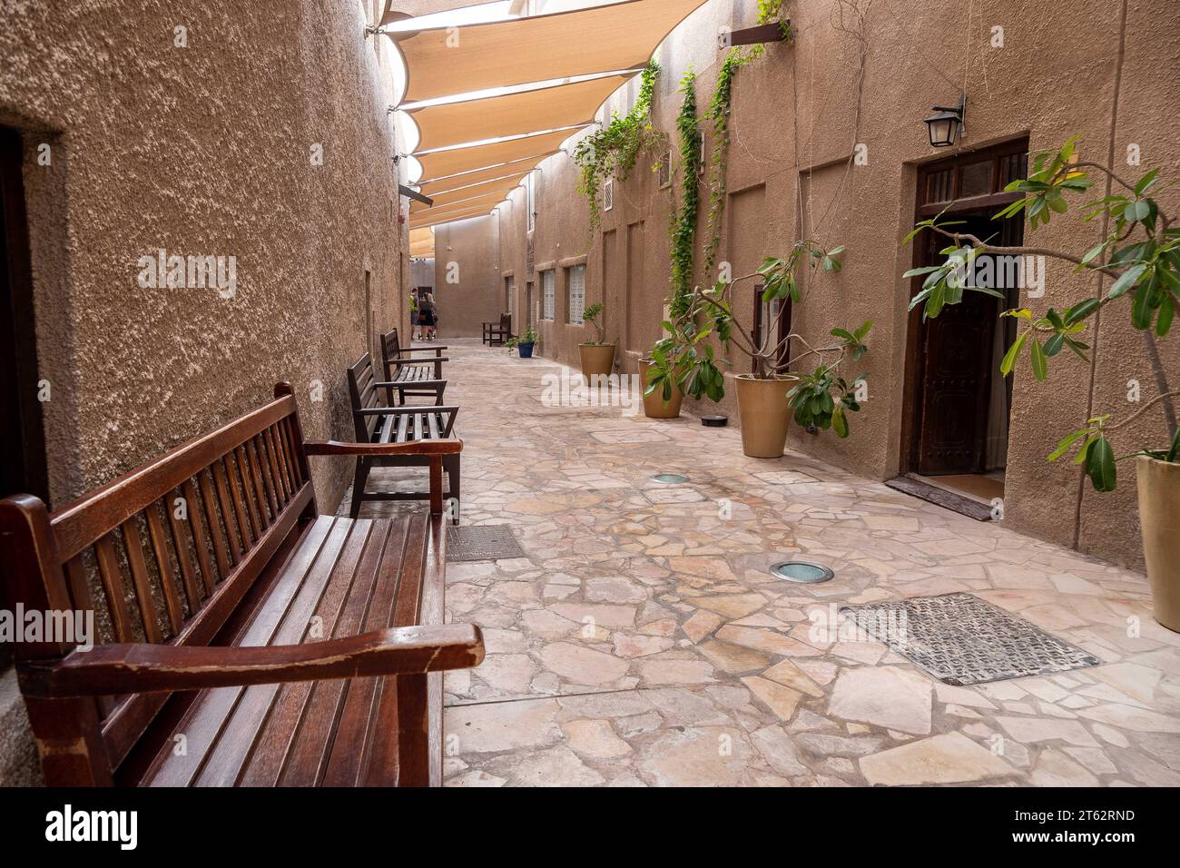 View of narrow clean streets between traditional stone buildings in old ...