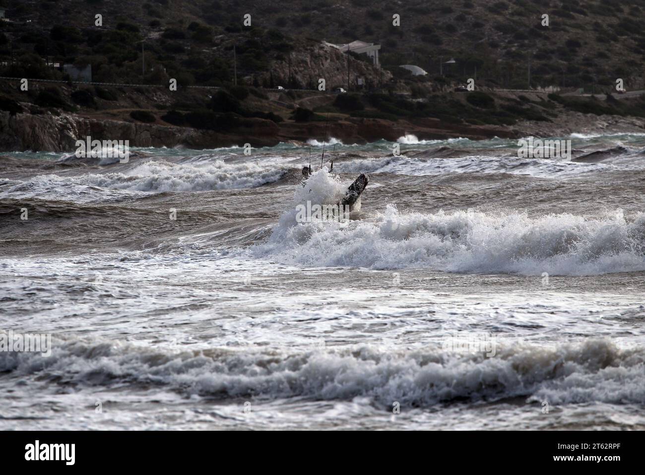 Kite surfing on beach Varkiza during the storm, brought about by a cold ...