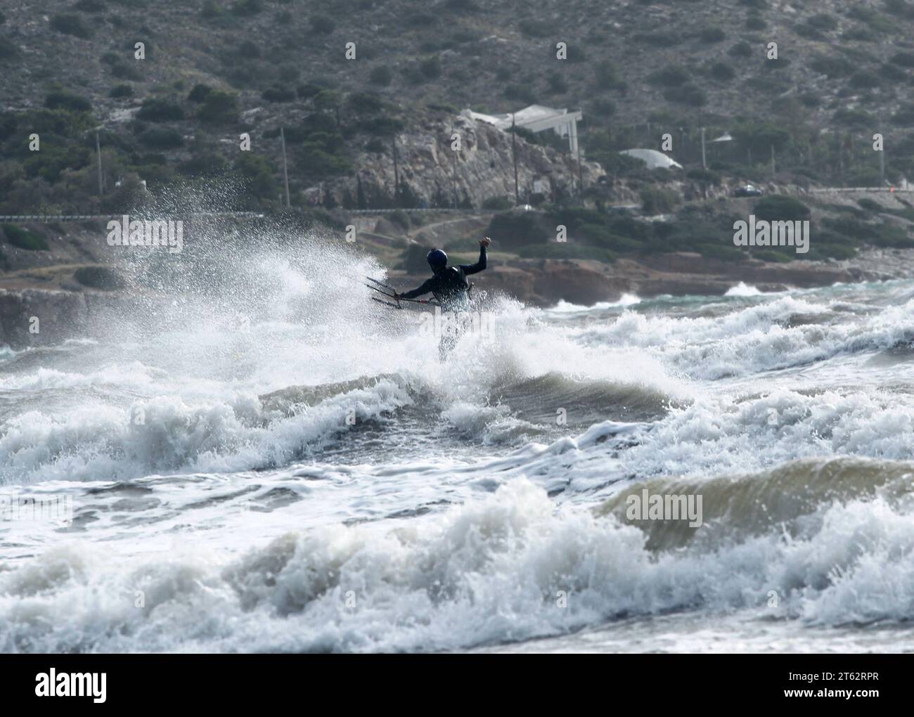 Kite surfing on beach Varkiza during the storm, brought about by a cold ...