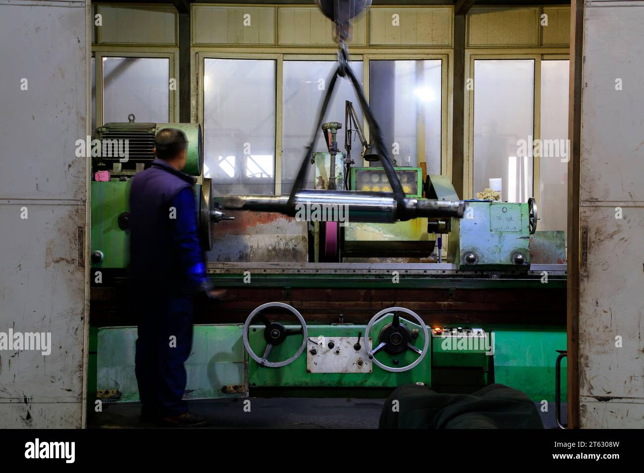 worker lifting mechanical roll Stock Photo - Alamy