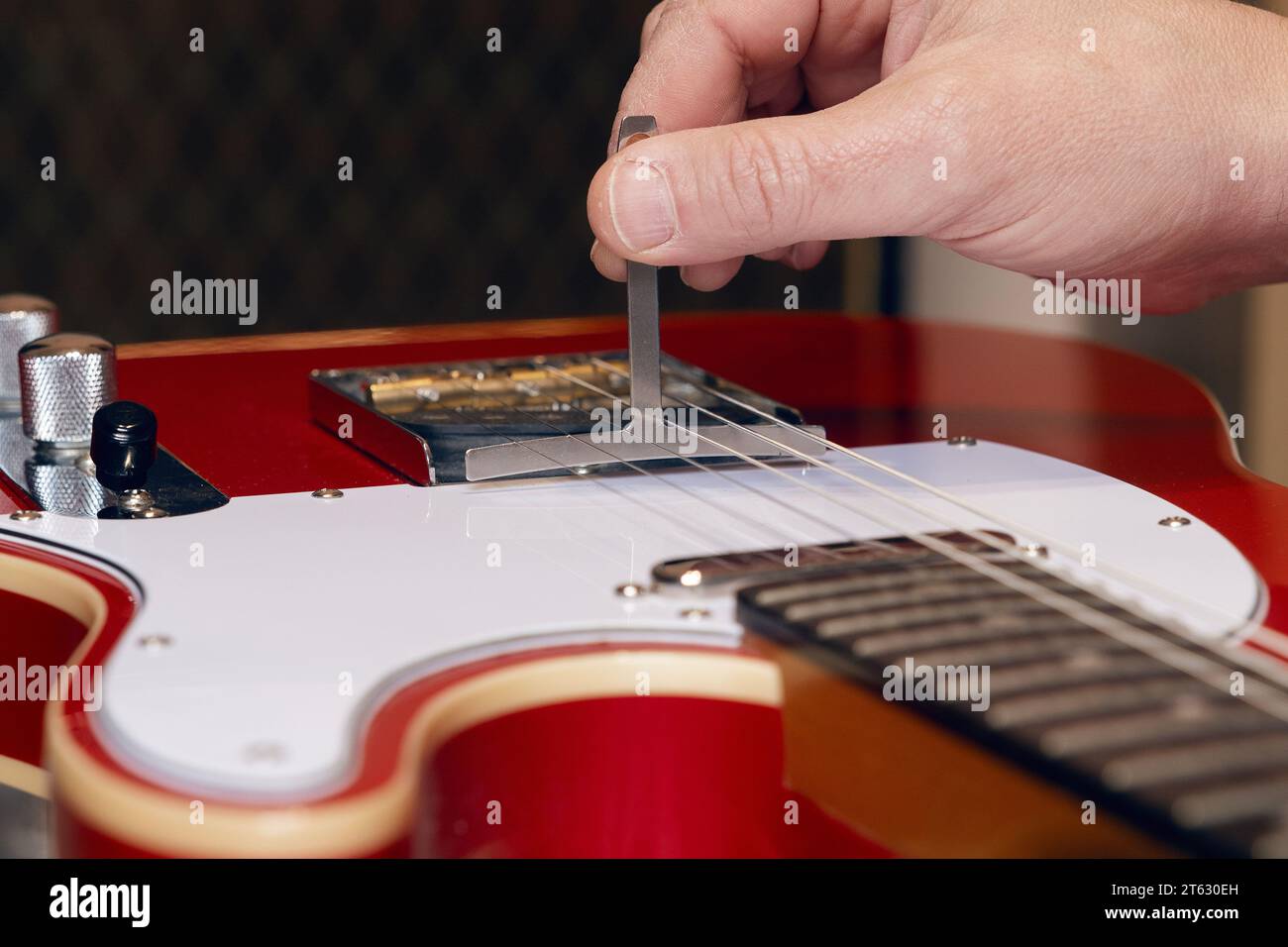 Luthier check guitar action using a radius gauge Stock Photo - Alamy
