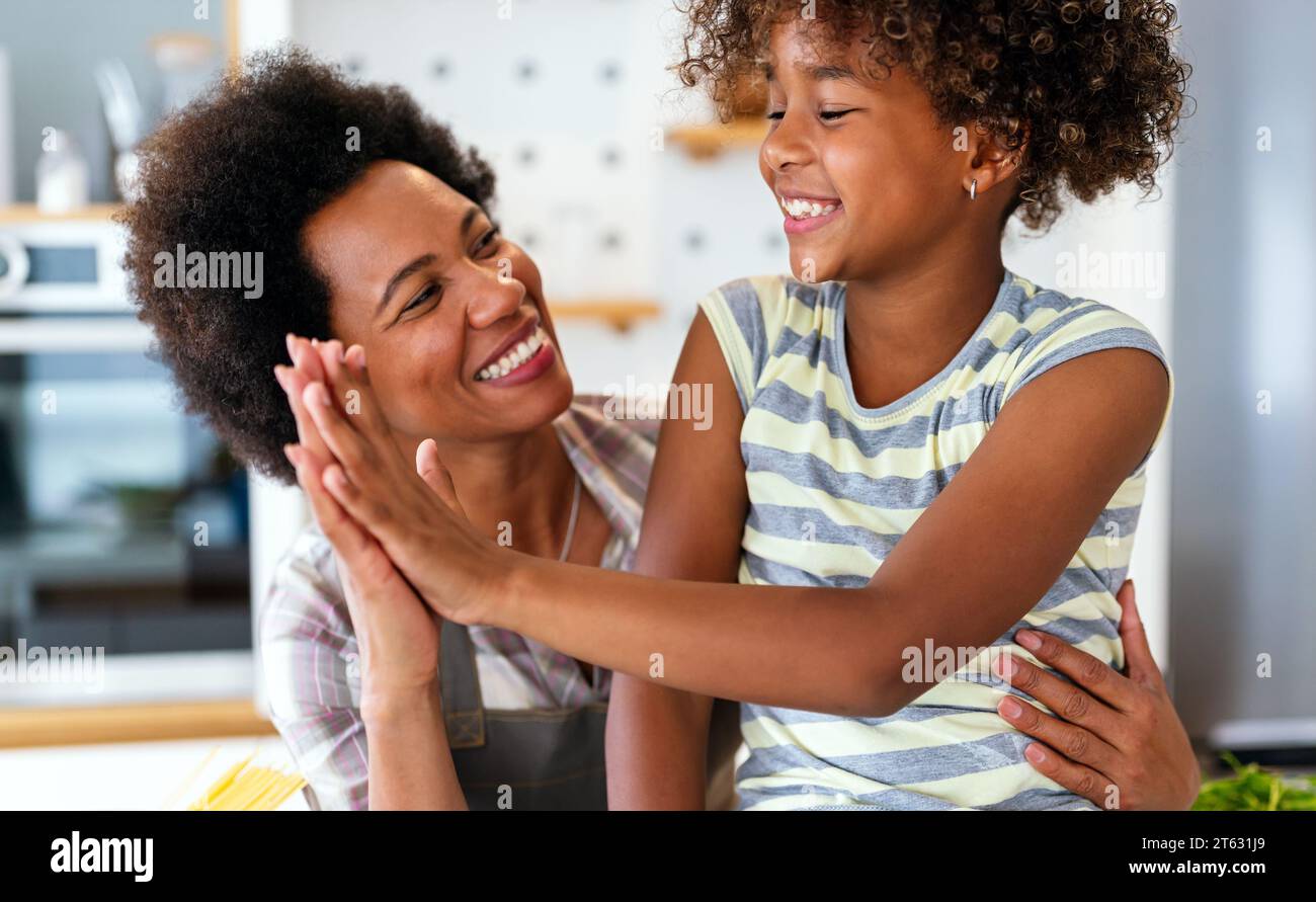 African american woman hugging her smiling teen daughter. Family love single parent child ...