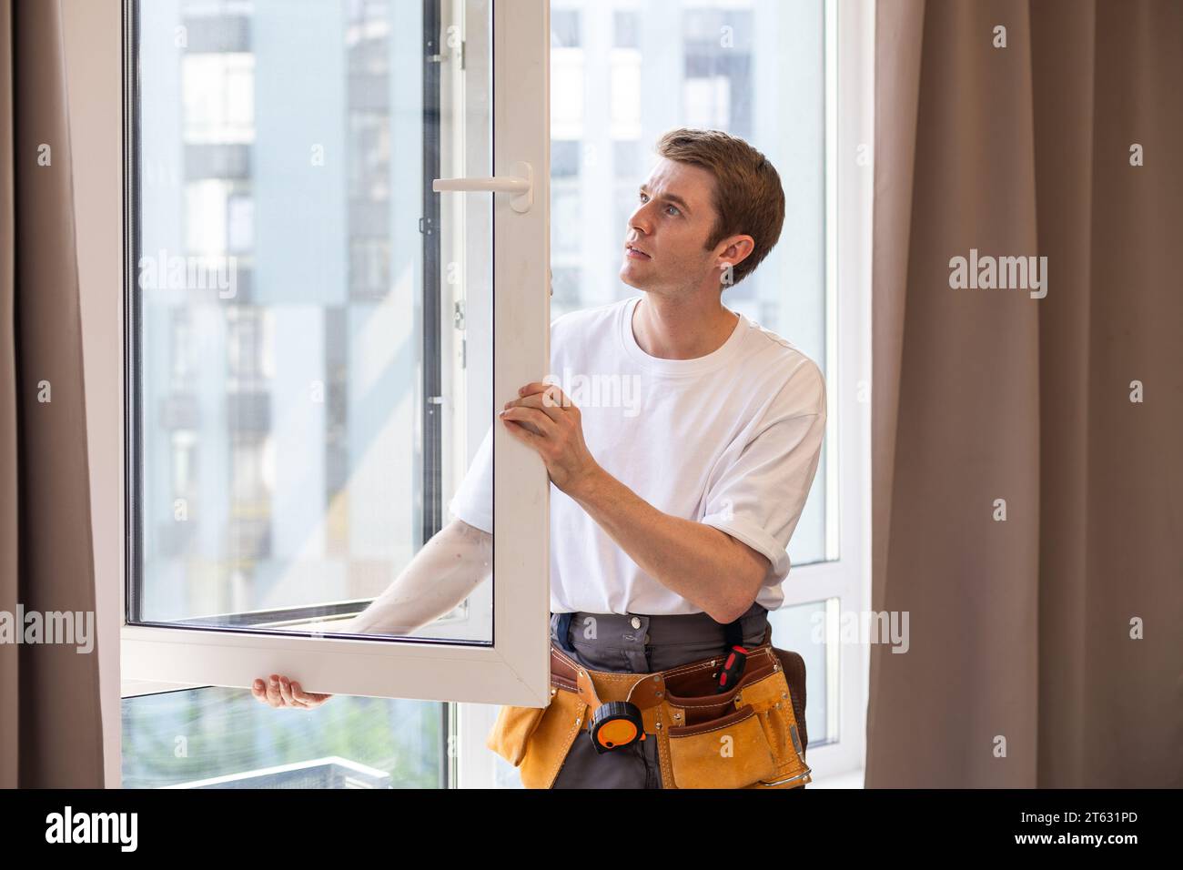 Construction worker installing window in house Stock Photo - Alamy