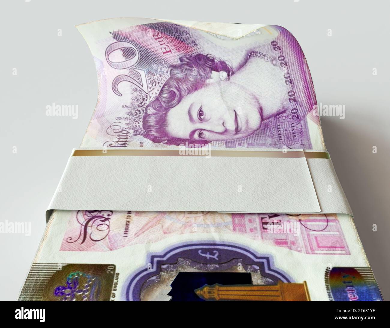 A bundled wad of british pound banknotes on an isolated light ...