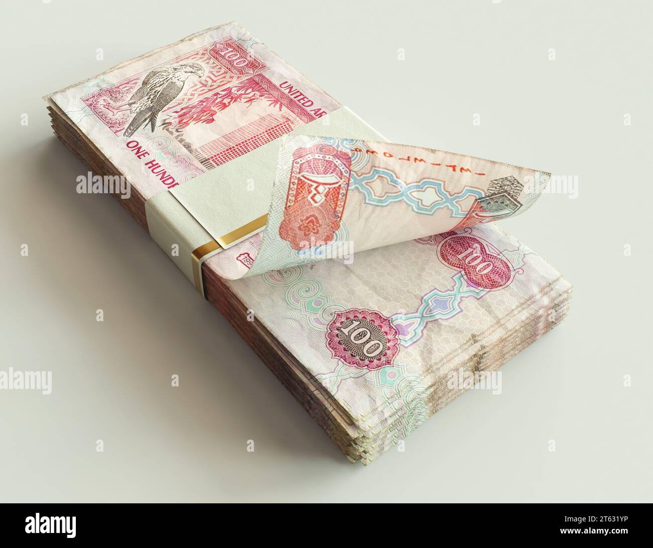 A bundled wad of UAE Dirham banknotes on an isolated light background ...